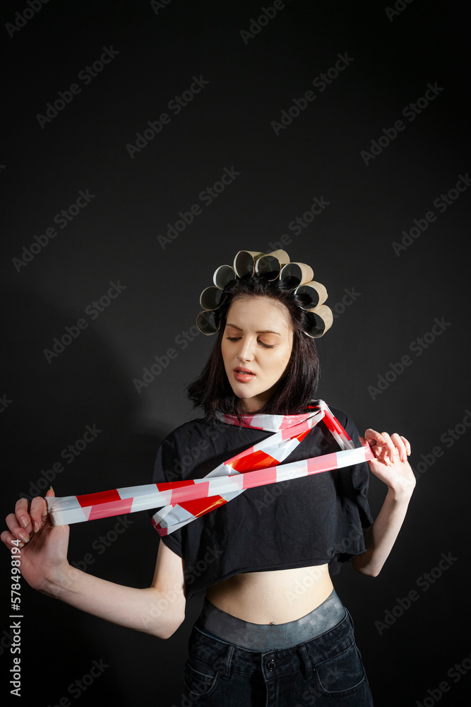 Portrait of a poor, skinny girl in black, rumpled clothes and a strange ...