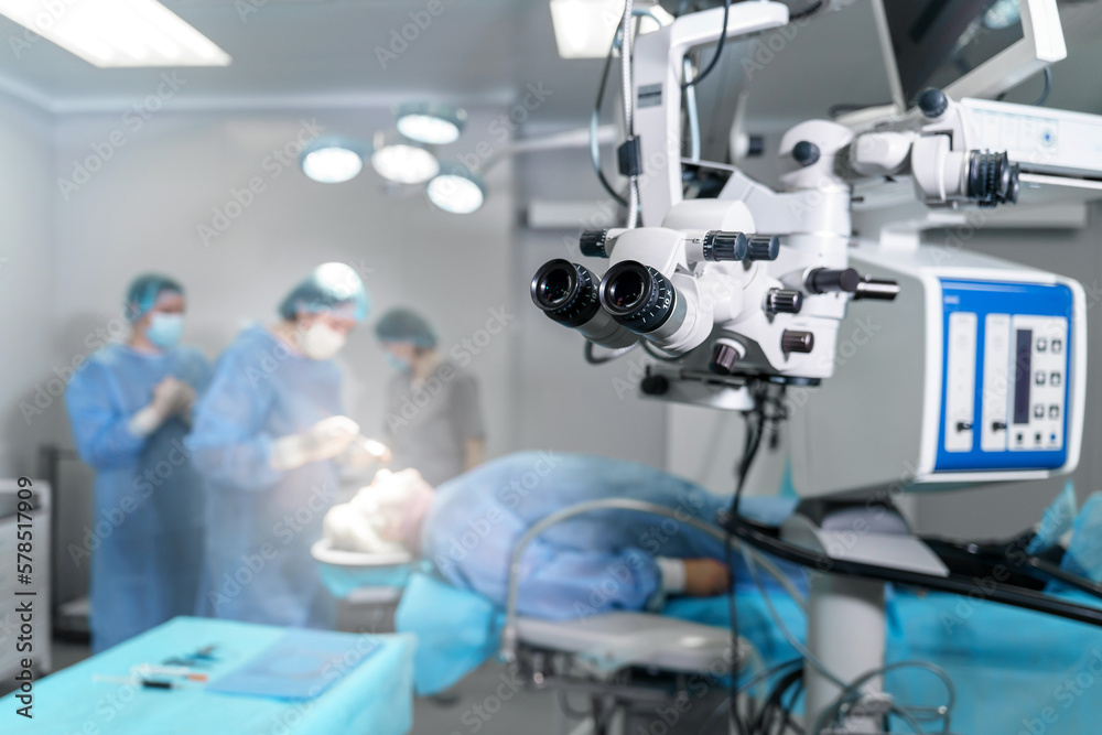 Surgical microscope in operating room with doctors. Ophthalmological ...