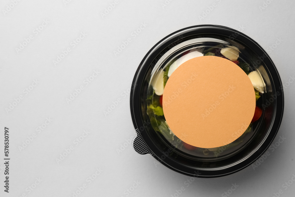 Tasty food in container on light background, top view. Space for text ...