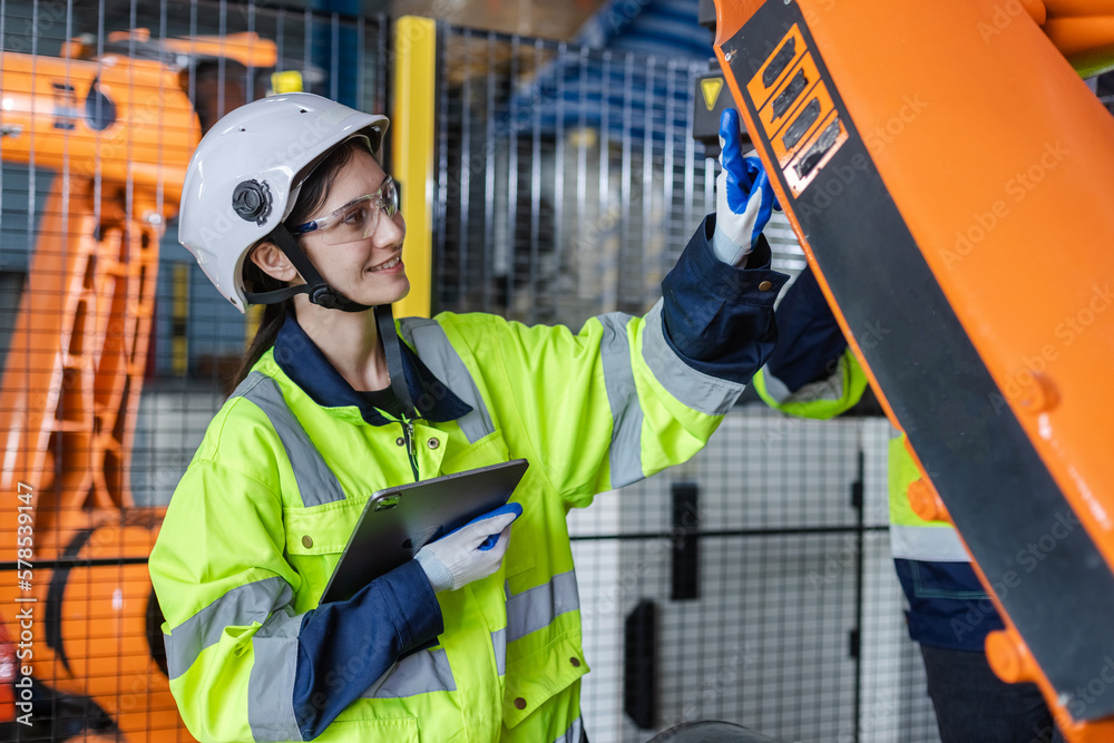 Female engineer using tablet checking system robot arm automate. robotic automation in line ...