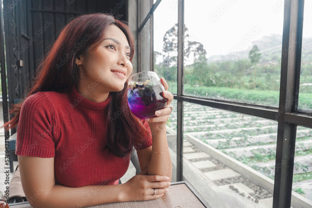 Portrait of joyful young woman enjoying a cup of tea at home. Smiling ...