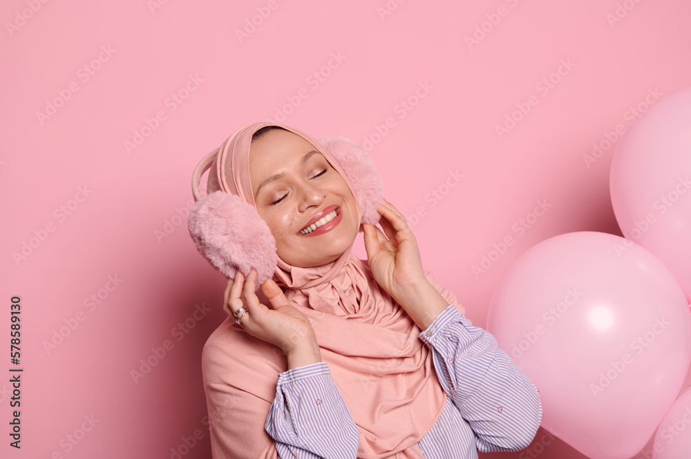 Delightful Muslim woman dressed in pink pastel hijab and blue shirt ...