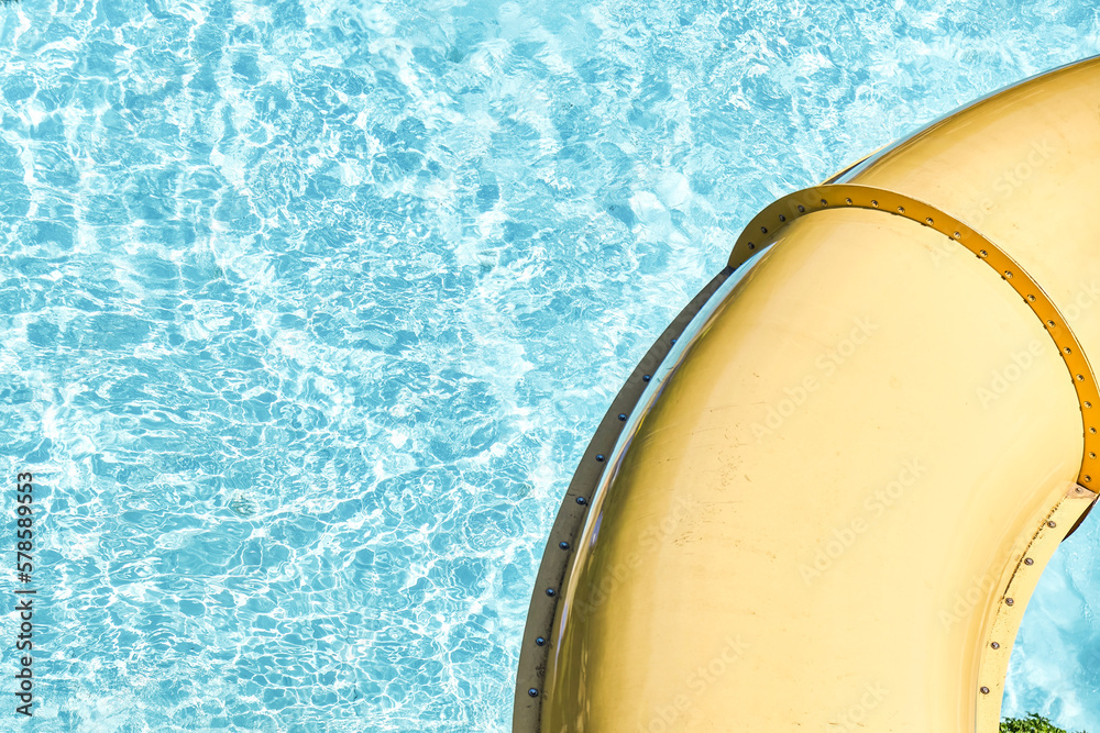 Water park slide pipe against blue clear water close up. Fun ...
