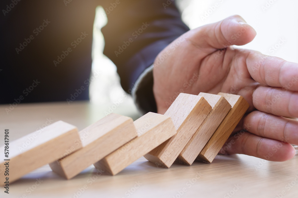 Protection finance from domino effect concept. Hands stop domino effect ...