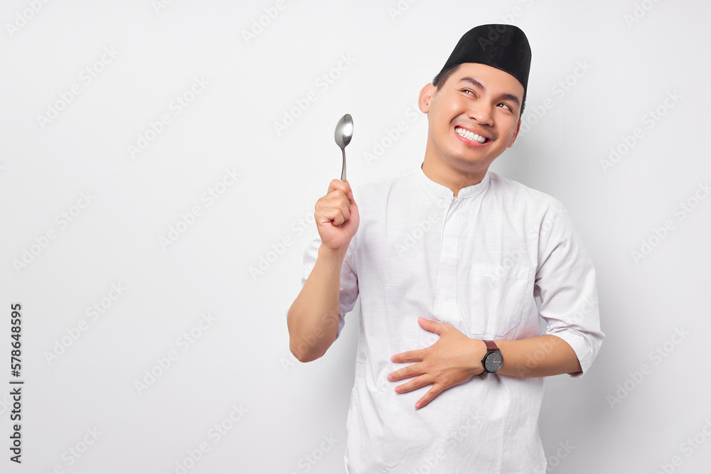 Feeling hungry young Asian Muslim man touching hand on the stomach ...