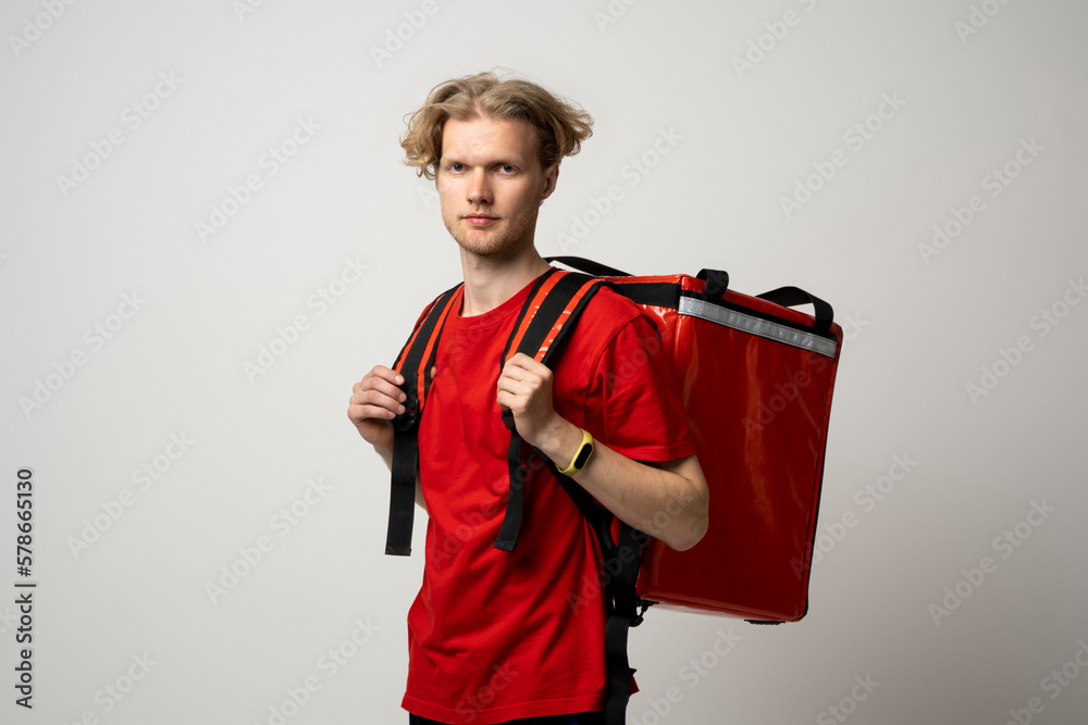 Delivery man in red uniform with thermal backpack for food. Takeaway ...