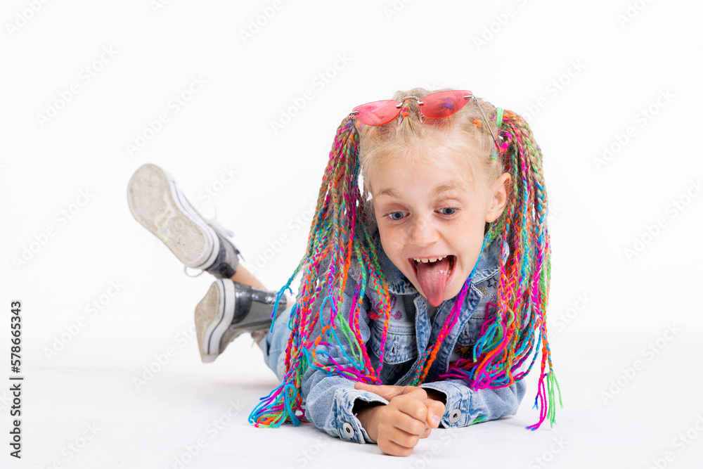 Beautiful adorable little daughter kid showing tongue having fun laying ...