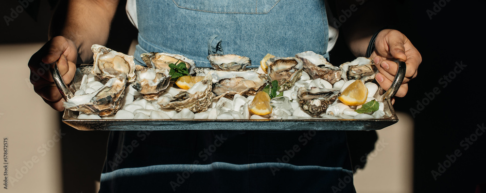 oyster. Man eating shellfish. Seafood and Mediterranean cuisine with ...