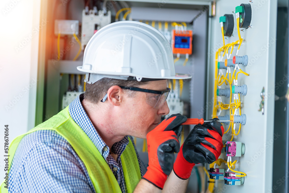 Electrician installing electrical wires and multimeter fuse switch box ...