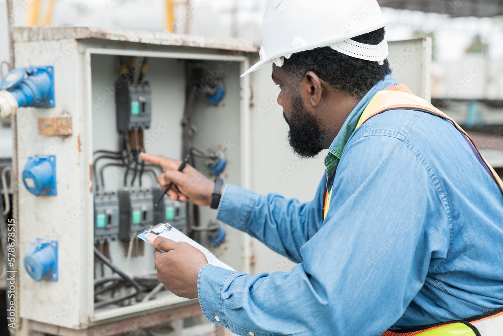 Male electrician maintenance electric system at construction site work ...