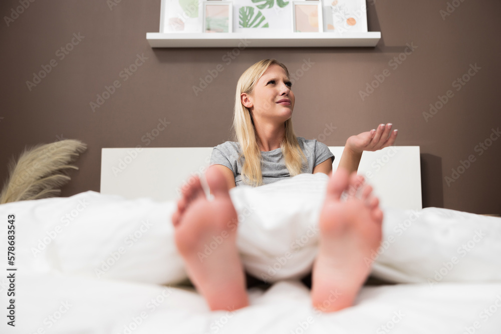 Confused blond young tired lady waking up in the morninh arguing with ...