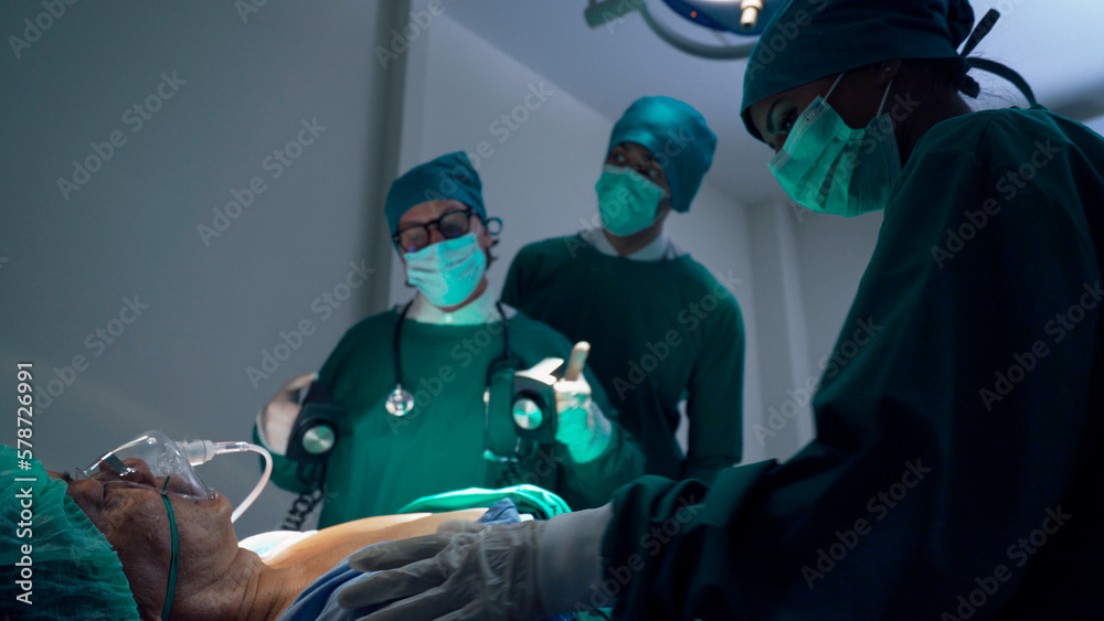 Doctor using defibrillator to pump at chest of patient to save life ...