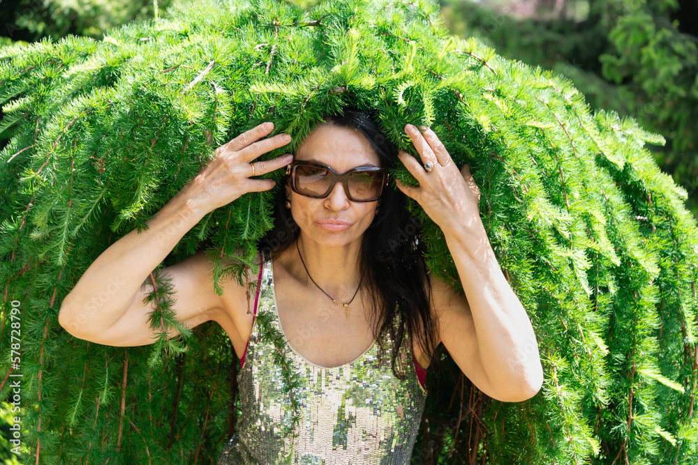 Portrait of a beautiful girl in sunglasses with hair from the green ...