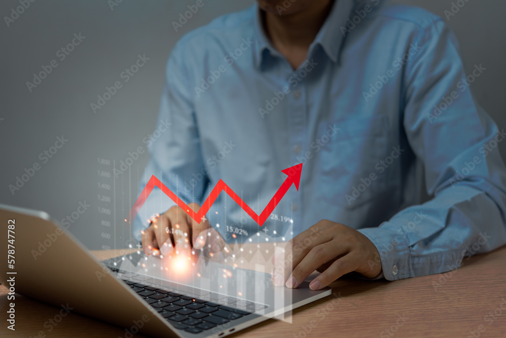 Foto de Businessman using laptop computer graph stock market and chart ...