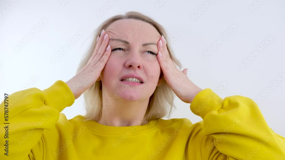 put your hands to your temples stretch your face a woman has headache ...