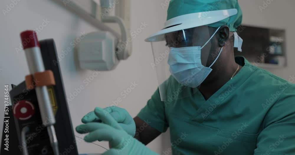 A surgeon is busy writing on the digital display of the electronic ...