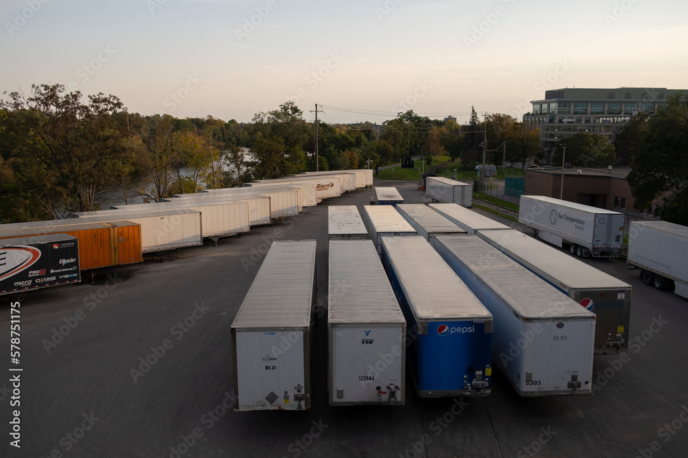 Many cargo shipping containers parked at a commercial truck driving ...