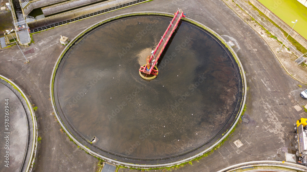 Aerial view of the tanks of a sewage and water treatment plant enabling ...