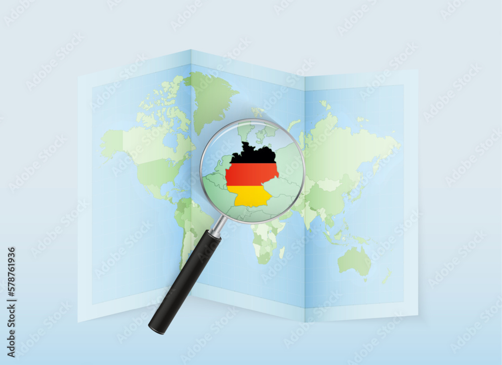 A folded world map with a magnifying lens pointing towards Germany. Map ...