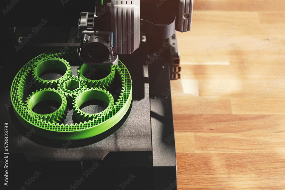 Black FDM-printer makes planetary gear machine part with visible infill ...