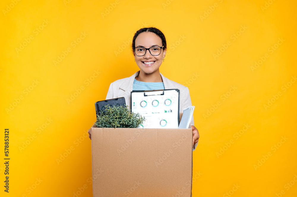 Positive mixed race young woman with glasses got a new job, holding ...