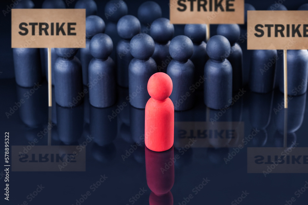 wooden figures of people holding signs and placards. concept of strike ...