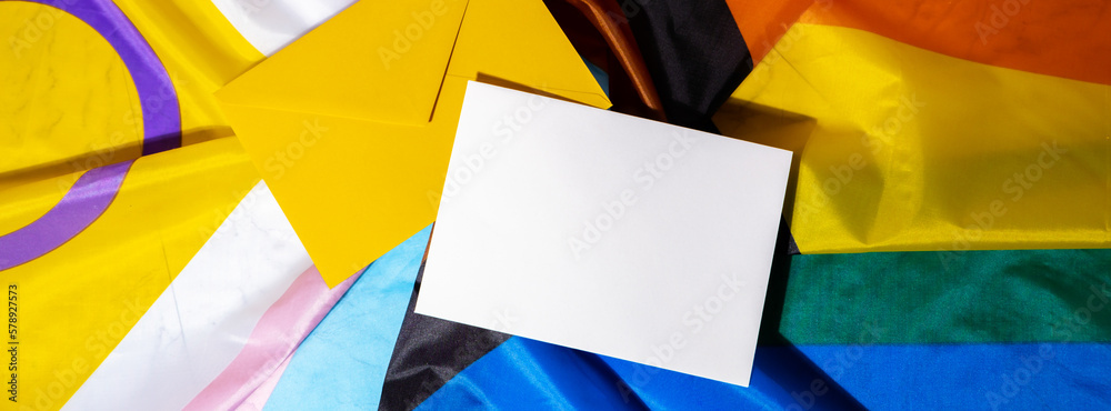 Banner Empty paper blank on Rainbow LGBTQIA flag made from silk ...