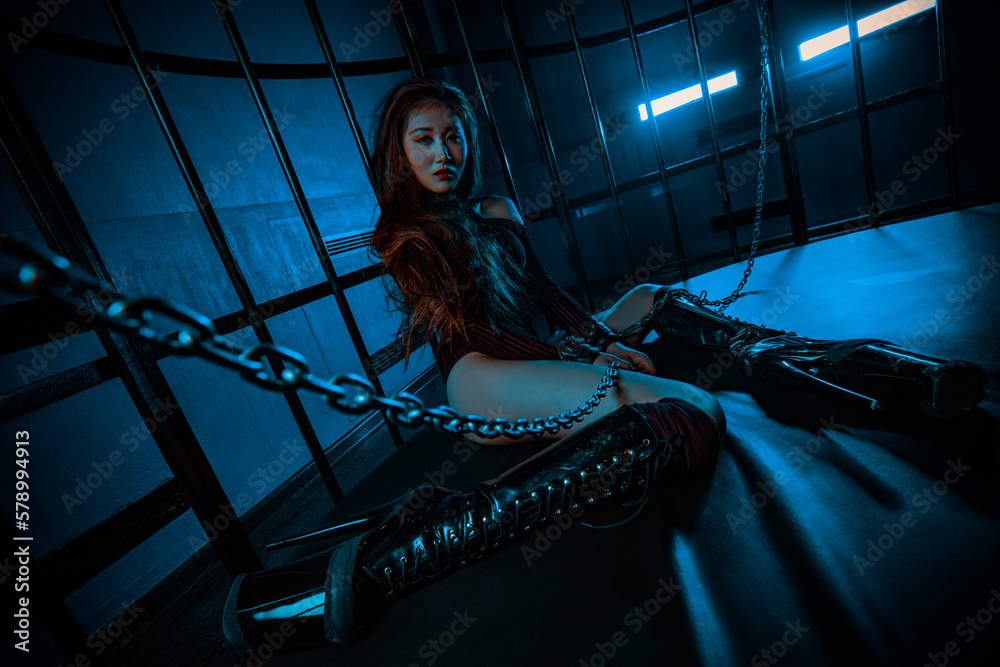 Young asian woman sitting in cage with chains bdsm style portrait Stock Photo | Adobe Stock