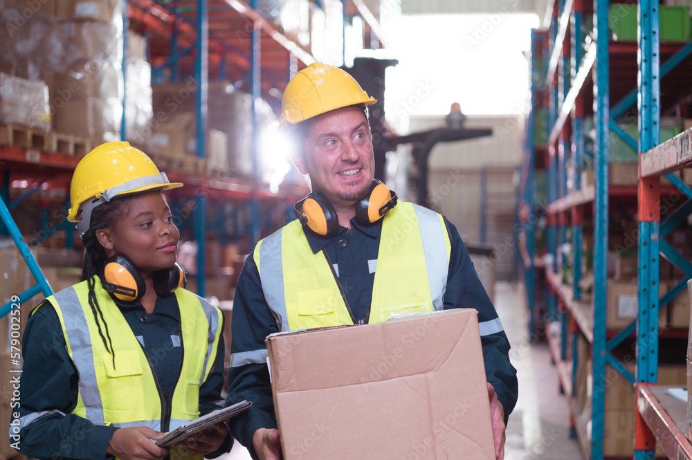Foreman with employees in warehouse Help each other lift the product ...