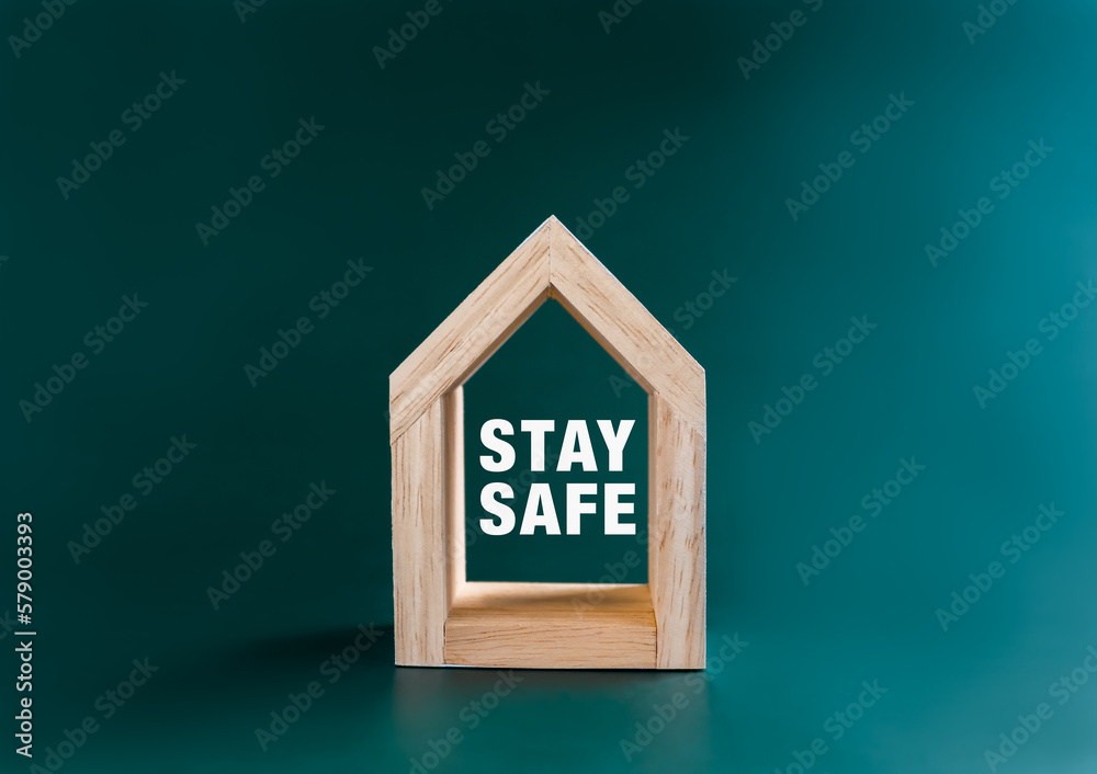 Stay safe concept. Word "Stay Safe" in wooden house isolated on aqua ...