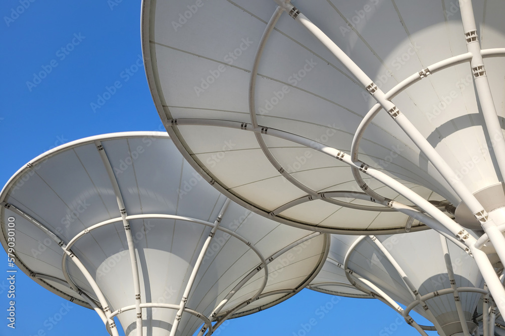 Low angle view huge canopies tensile membrane structure against sunny ...