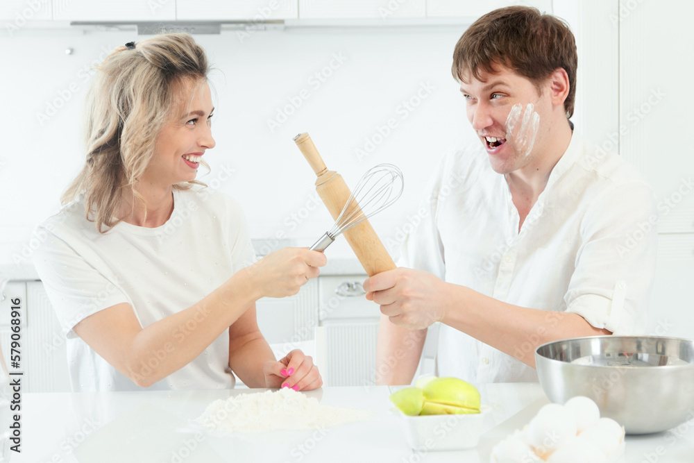 Husband and wife quarrel in kitchen while cooking. Comic and cheerful ...