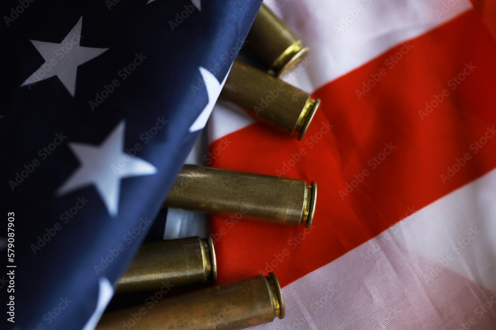 Many bullets cartridges and medals on United States flag. Concept of ...