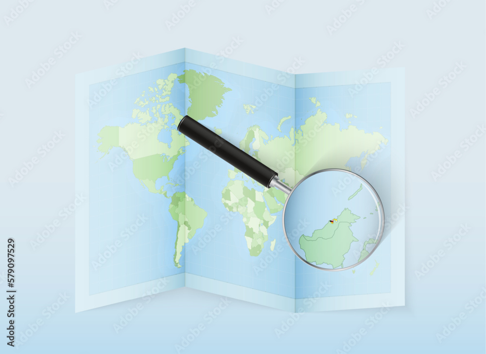 A folded world map with a magnifying lens pointing towards Brunei. Map ...