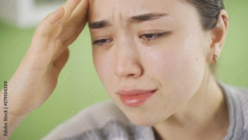 Depressed asian young woman crying, having a crying crisis. Unhappy and ...