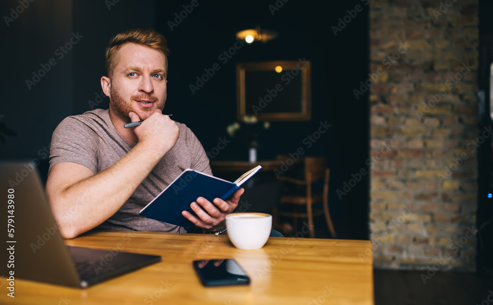 Skilled male copywriter with education notepad thinking about ...