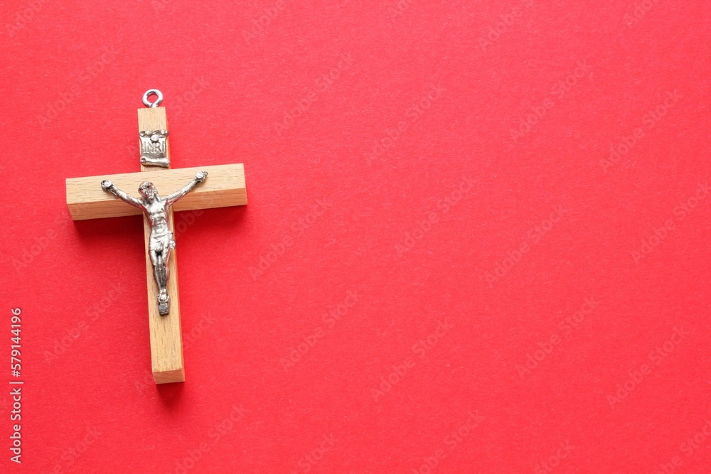 Crucifix christian wooden cross on red background with copy space ...