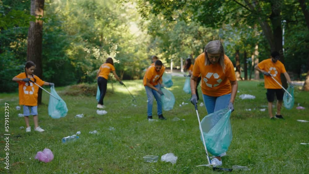 Group Of Multiethnic Eco Activists In T-Shirts With Recycling Symbol ...