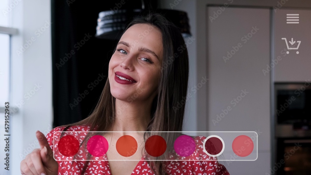 A beautiful woman chooses a lipstick color in a virtual store menu with ...