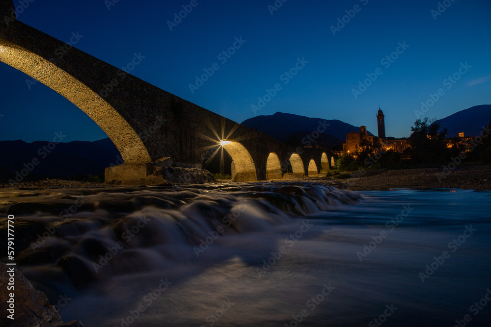 Ponte Gobbo in the town of Bobbio during sunset or also called devil's ...
