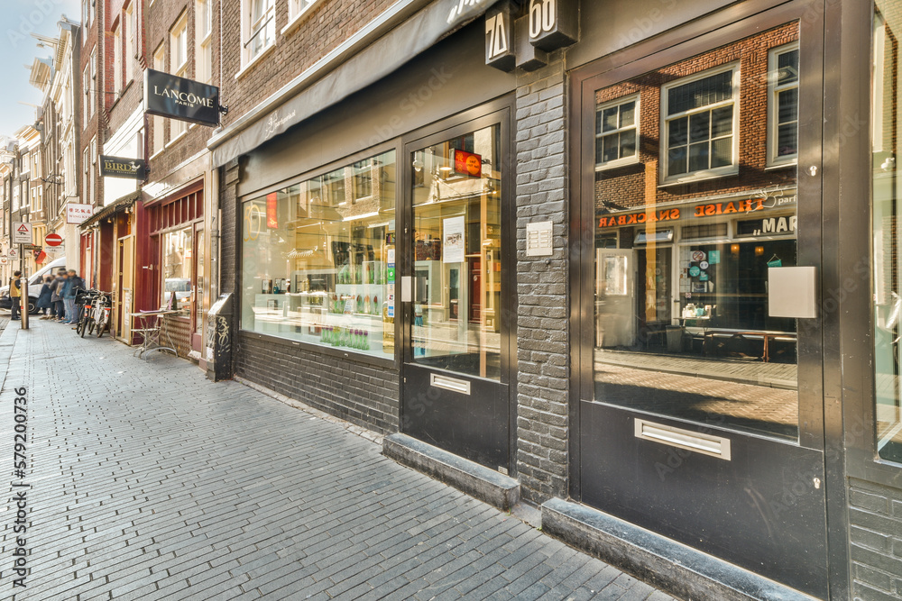 an empty city street with people walking on the sidewalk and buildings ...