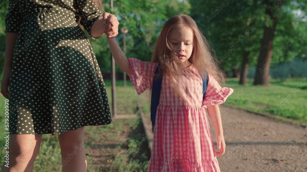 Child girl with briefcase goes to school with her mom. Mom and daughter ...