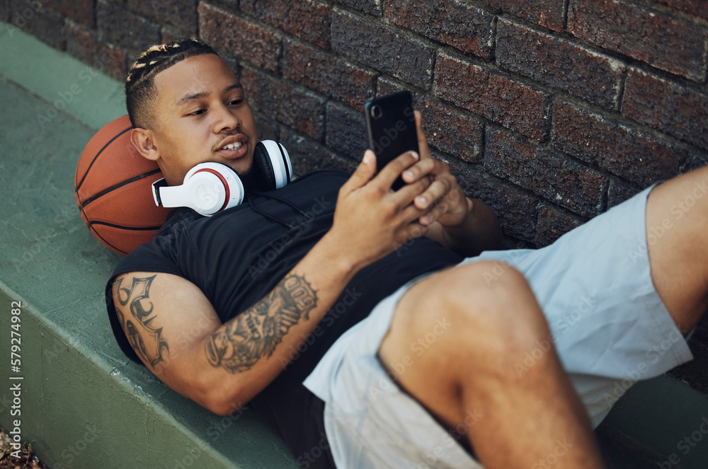 Basketball player, phone and fitness app on break after sports match ...