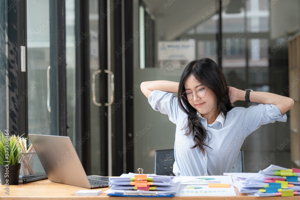 Asian businesswoman feel tired from hard work, thus doing arm ...