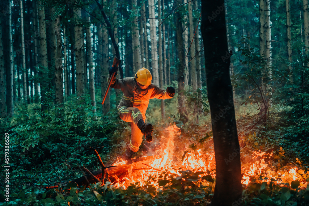 firefighter hero in action danger jumping over fire flame to rescue and ...