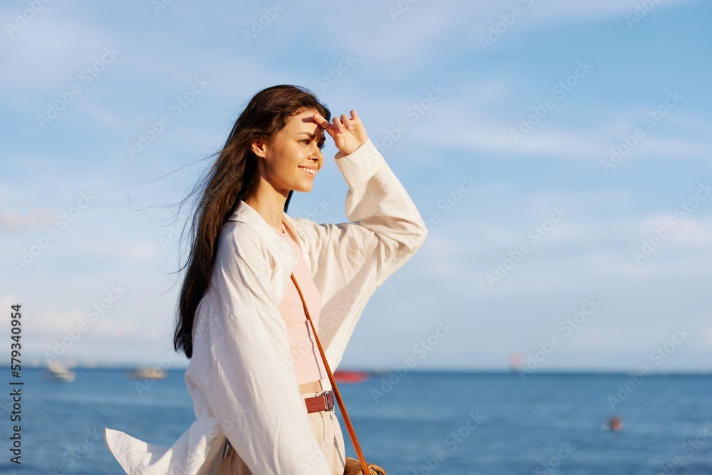 Woman happiness with eyes closed in the sun walking on the beach ...
