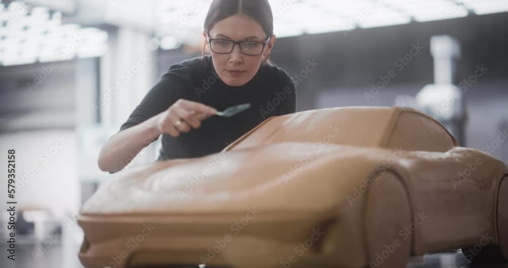 Portrait of a Female Automotive Designer Sculpting a 3D Clay Model of a ...
