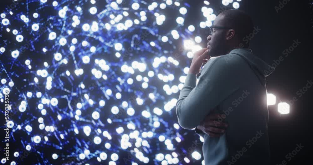 Black Young Man Looking at a Big Screen with Neural Network ...