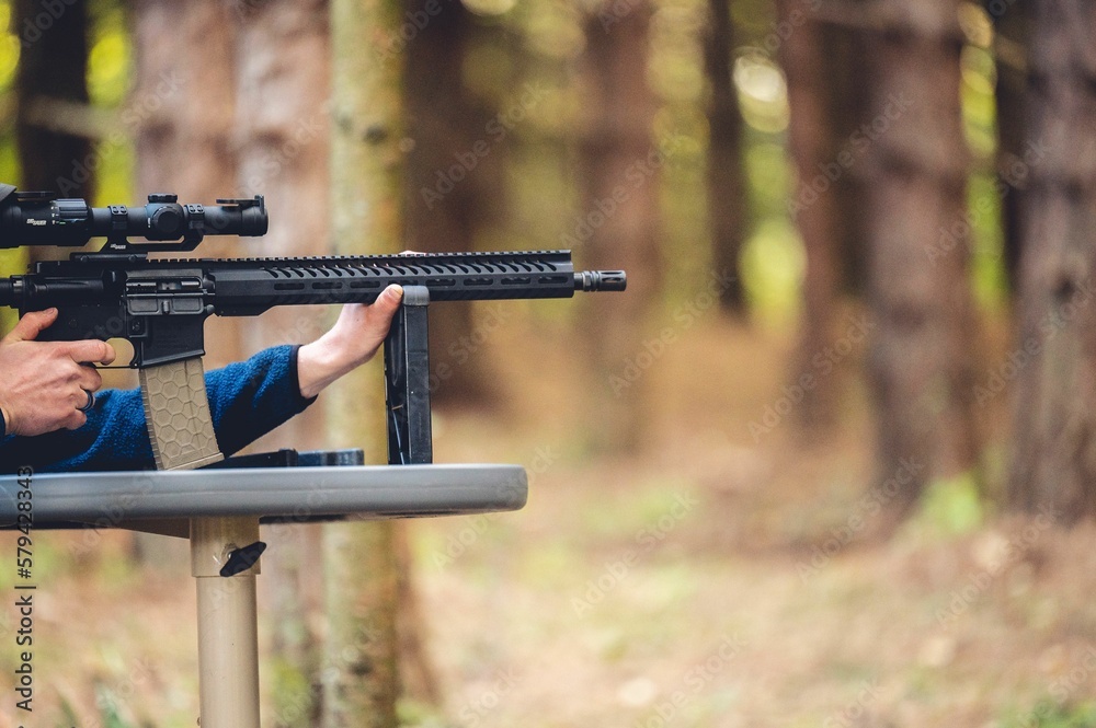 Man shooting from a rifle AR 15 outdoors on the shooting range Stock ...