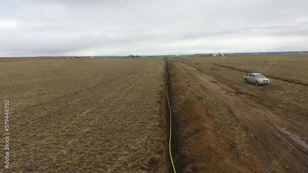 Heavy machinery making a trench for the placement of a gas pipeline ...